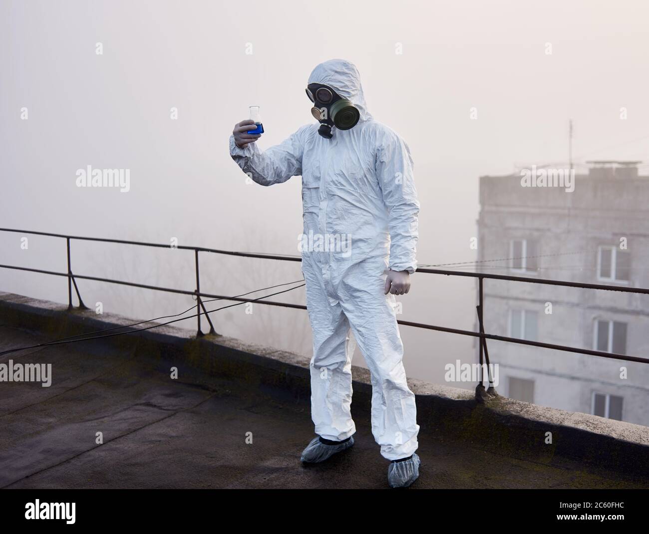 Full length shot of male scientist standing on top of a high storey ...