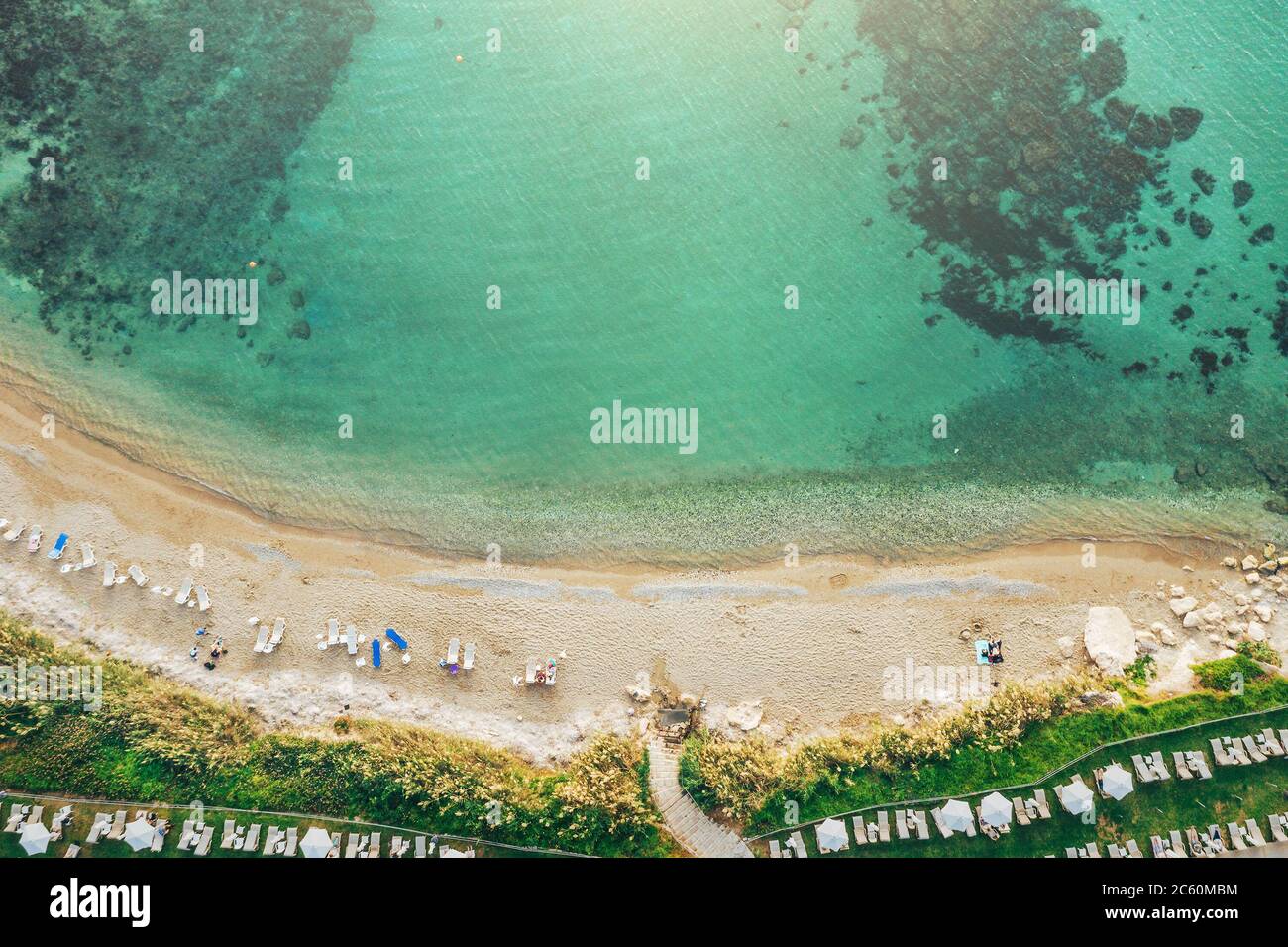 Cyprus sea coast with sandy beach, sunbeds and umbrellas, aerial top ...