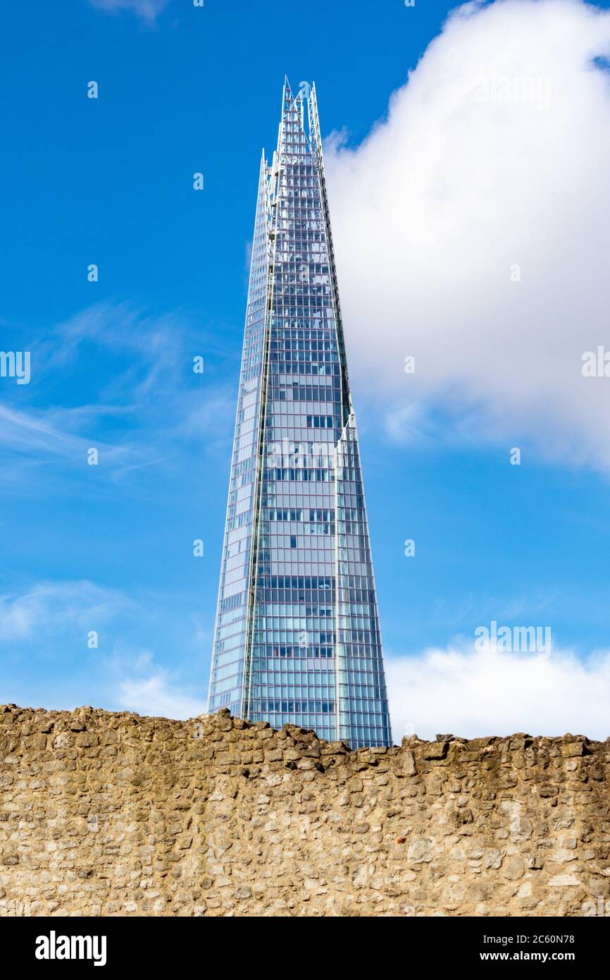 The Shard rising from beyond a remnant of the old Roman Wall of London ...