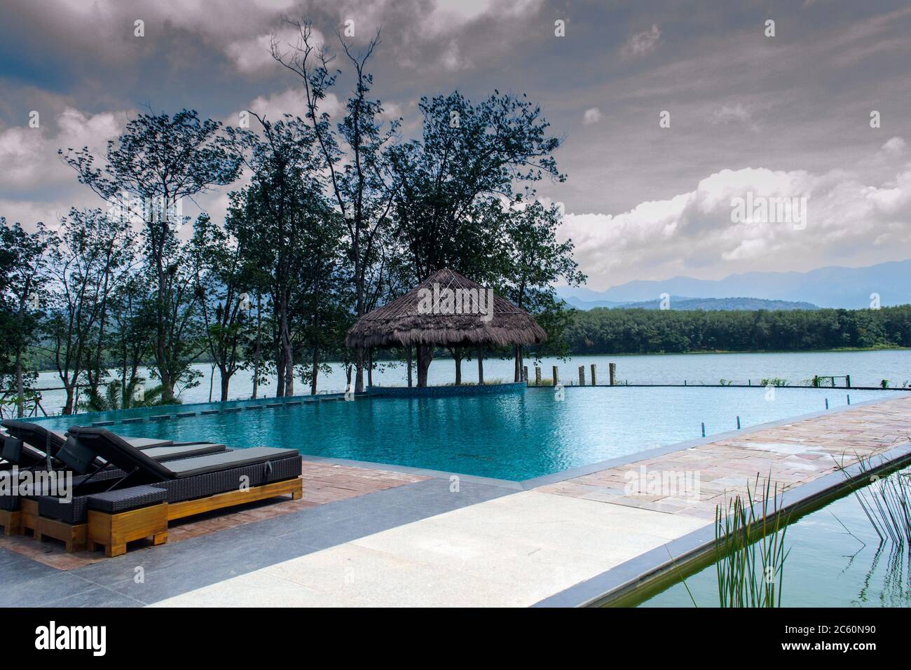 a small shade made with straw with lake facing swimming pool Stock ...