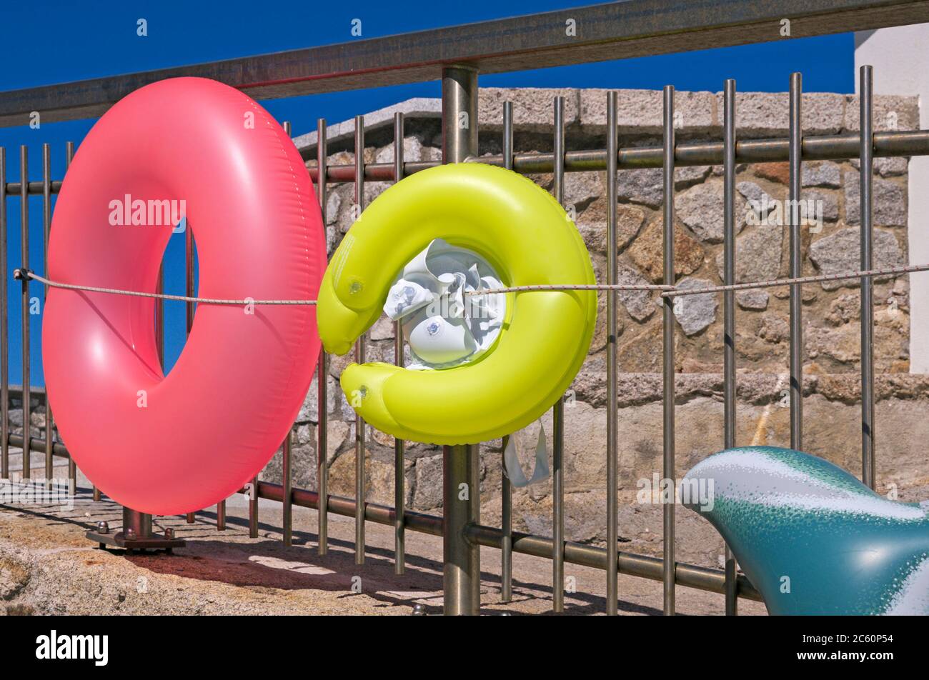 colourful floating rings hanging on railing Stock Photo - Alamy