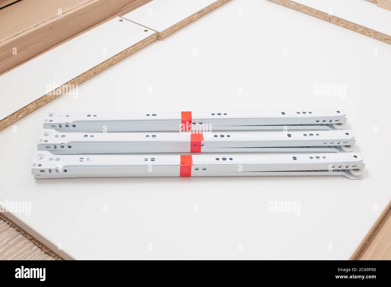 Roller guides for installation during furniture assembly, background ...