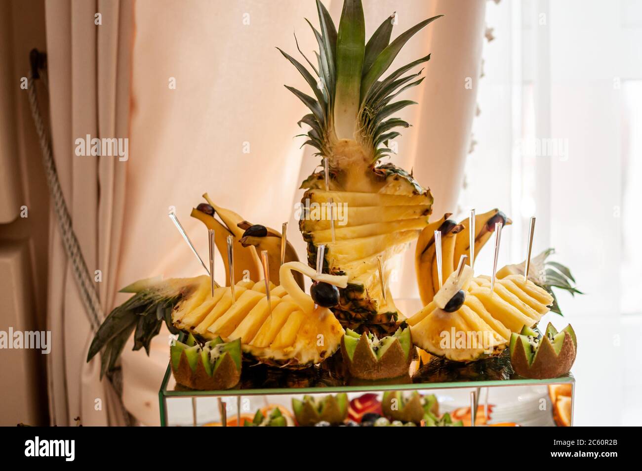 Pineapple slicing at the wedding buffet Stock Photo - Alamy
