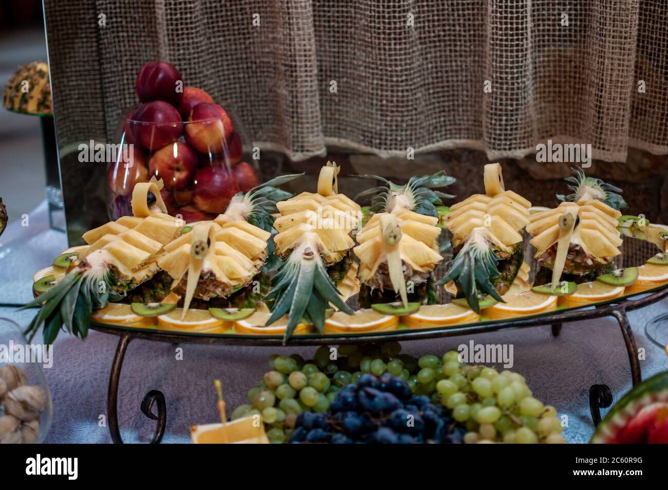 Pineapple slicing at the wedding buffet Stock Photo - Alamy