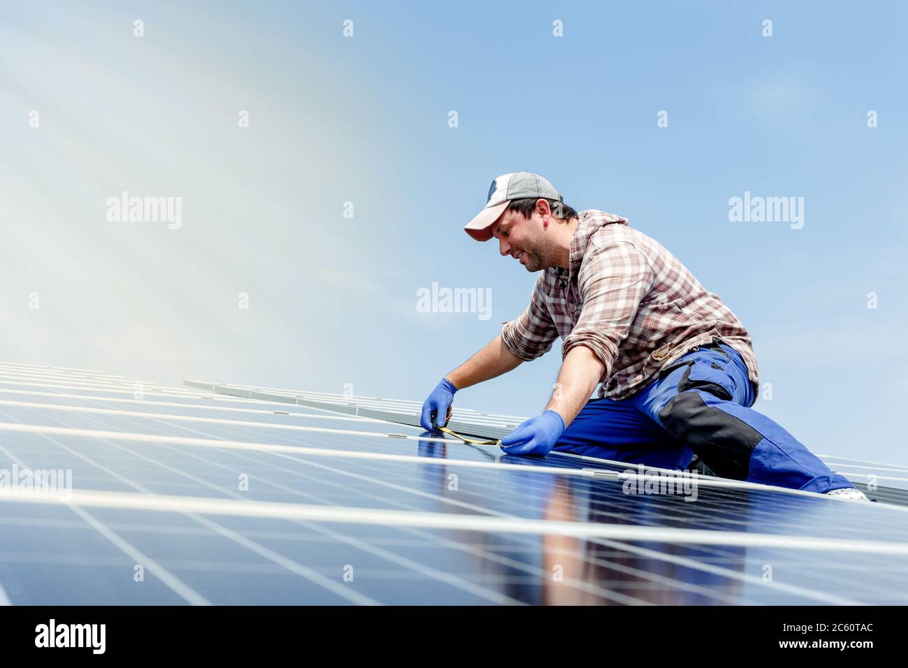 Solar panel energy. Electrical engineer man is working in solar station ...