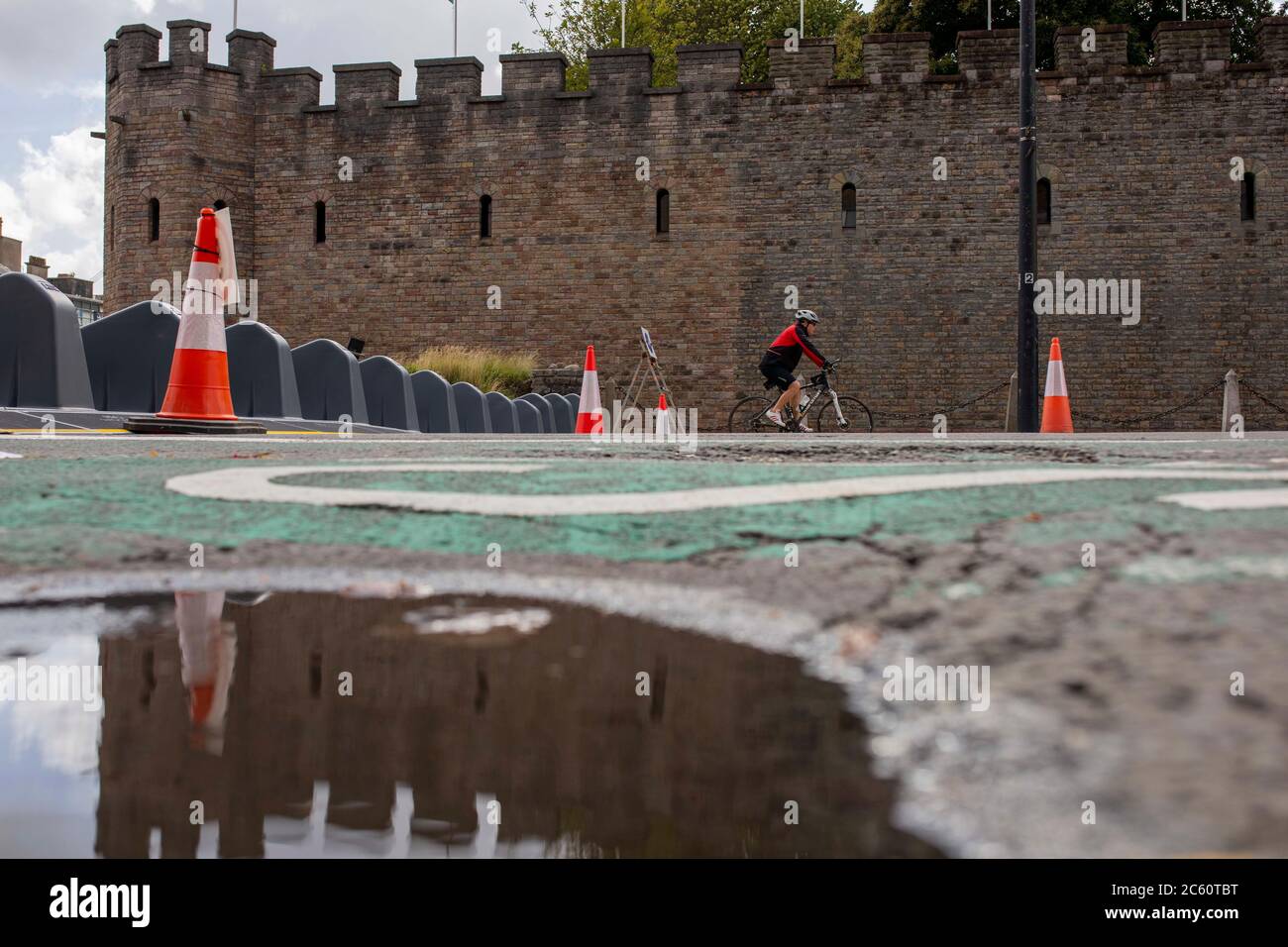 A cyclist passes between newly introduced bollards and a cycle bumps in ...