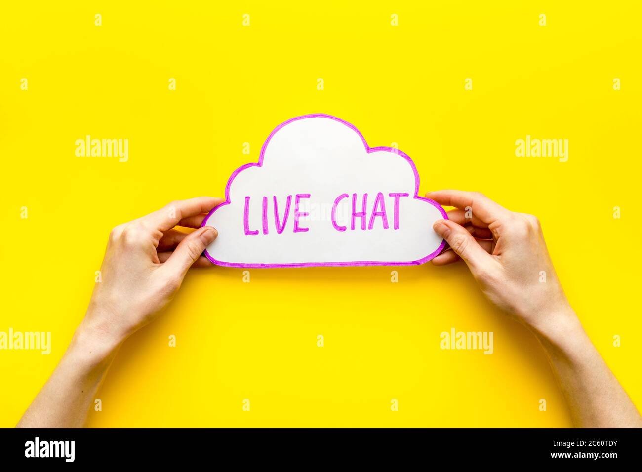 Live chat concept - bubble in hands on yellow table top view Stock ...