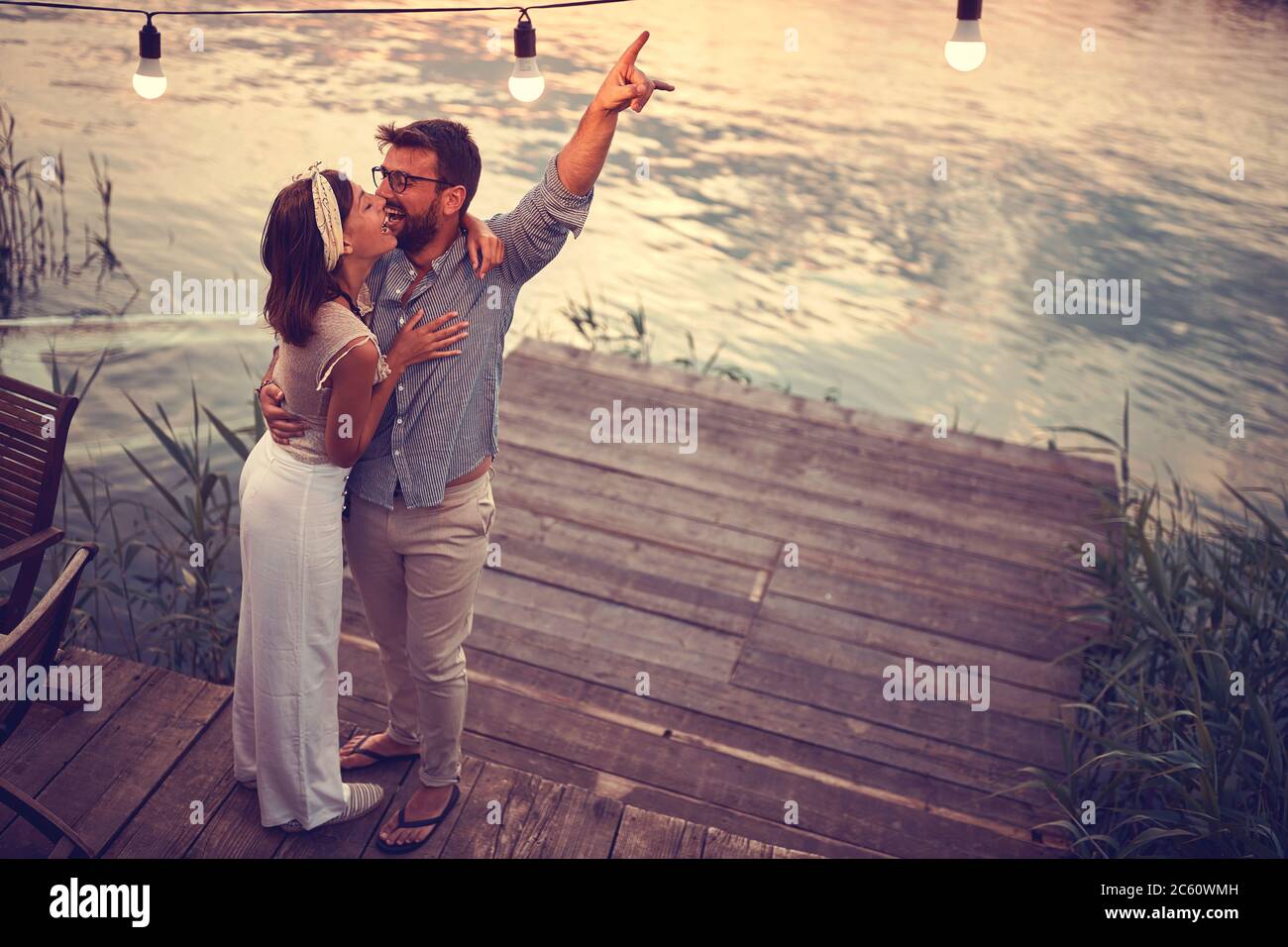 top view of a couple hugging and smiling on the riverside Stock Photo ...