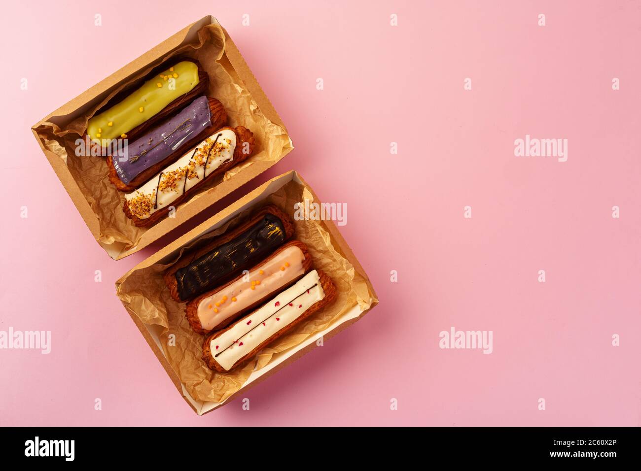 Box with fresh eclairs on pink background Stock Photo - Alamy
