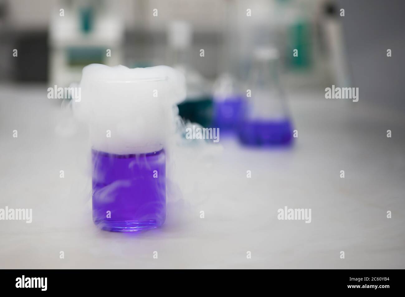 Smoking purple chemical solutions in a science laboratory. Analytical ...