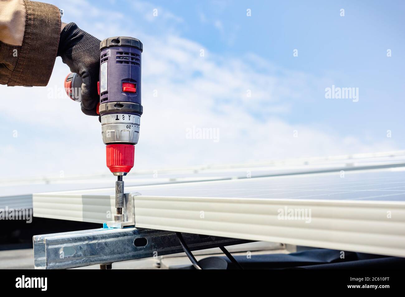 Solar engineer male hand working with drill installing solar panel on ...
