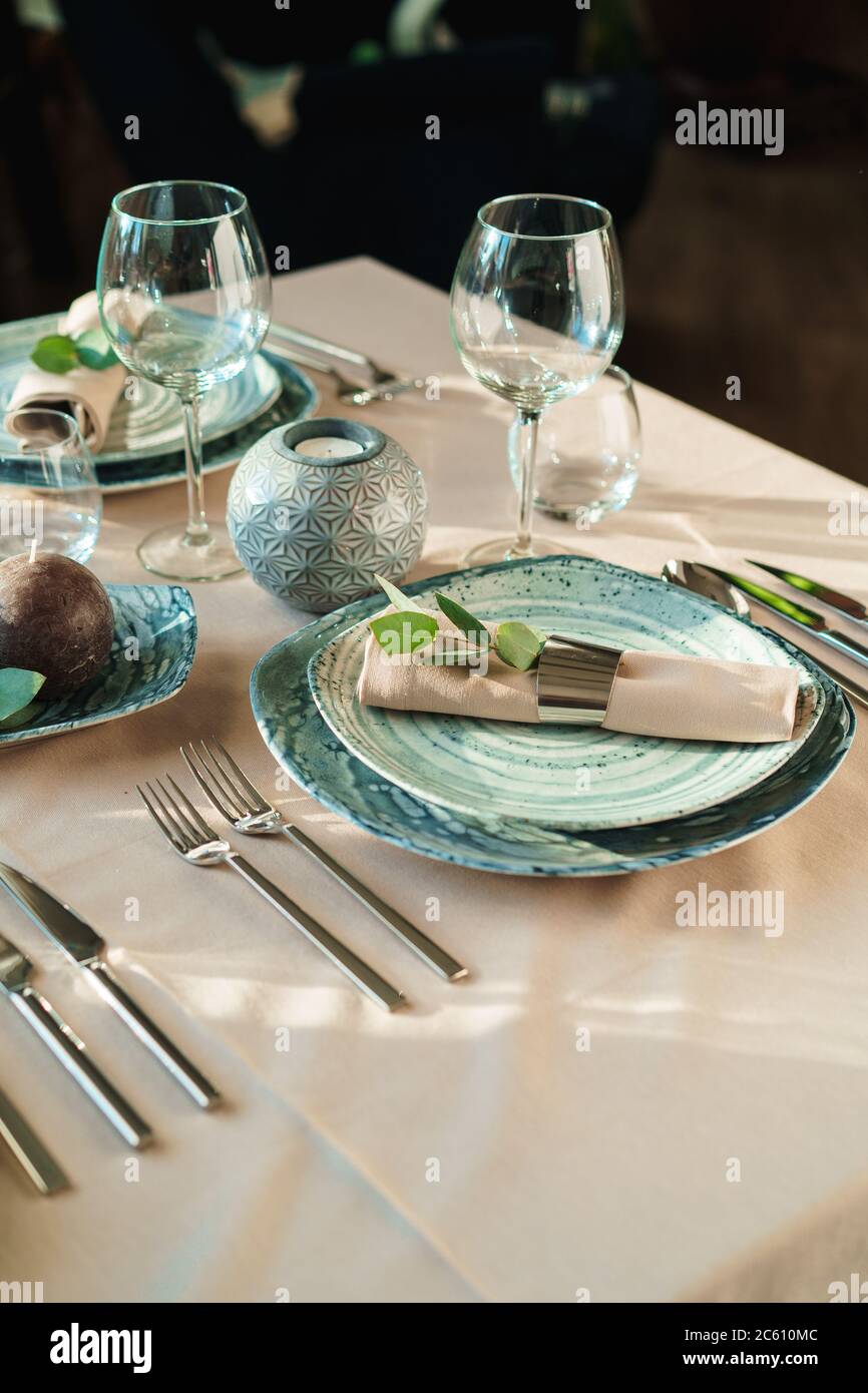 Luxury green table setting decorated with candles Stock Photo - Alamy