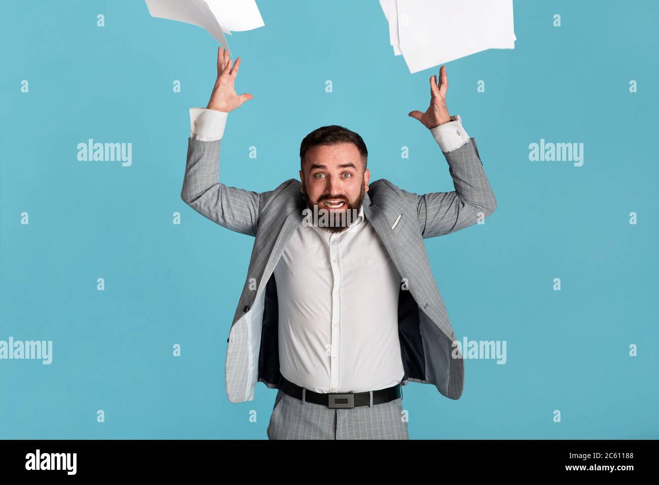 Work stress management. Angry millennial office employee throwing ...