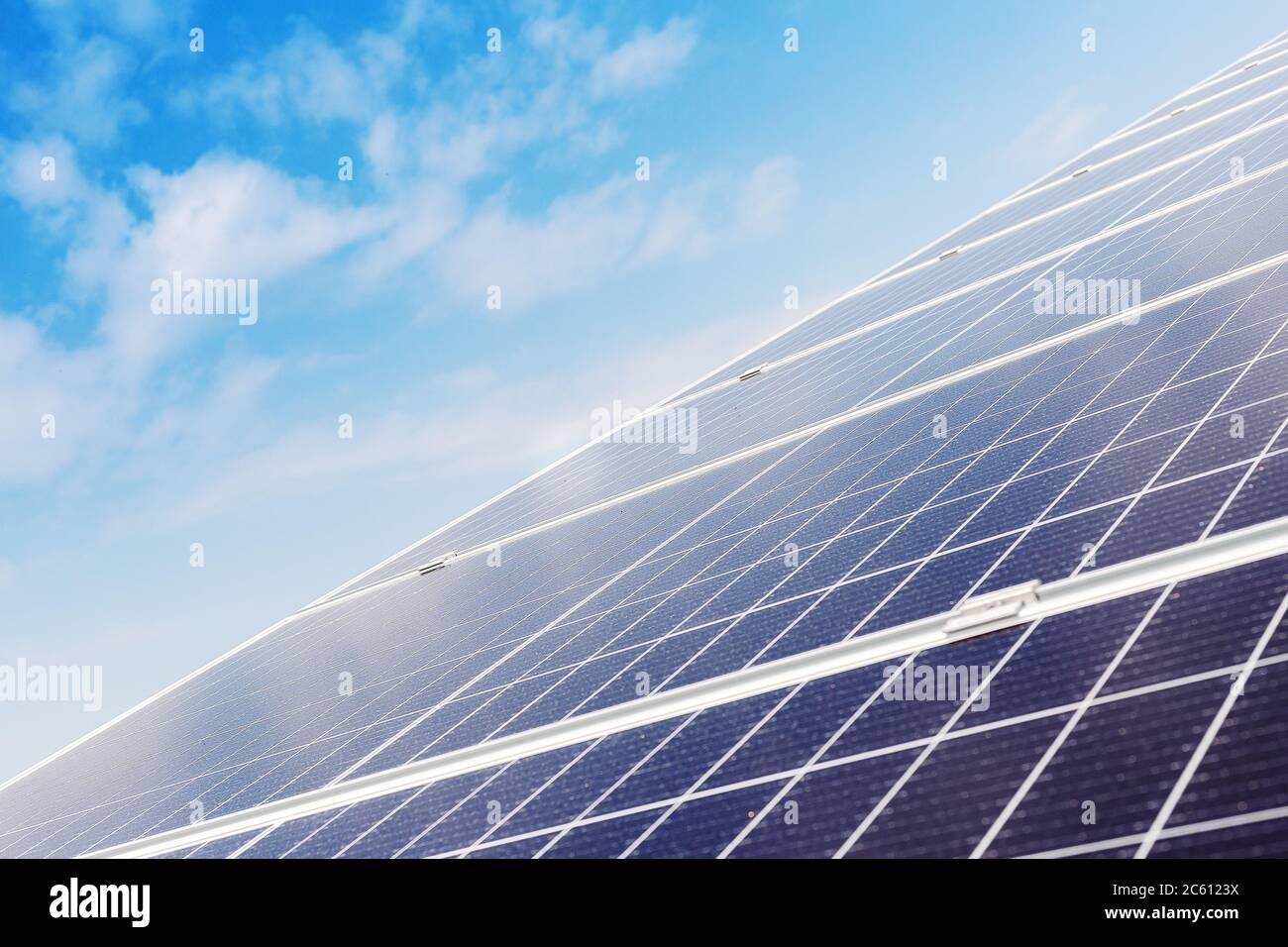 Solar panels on house roof against blue sky. Solar energy power station ...