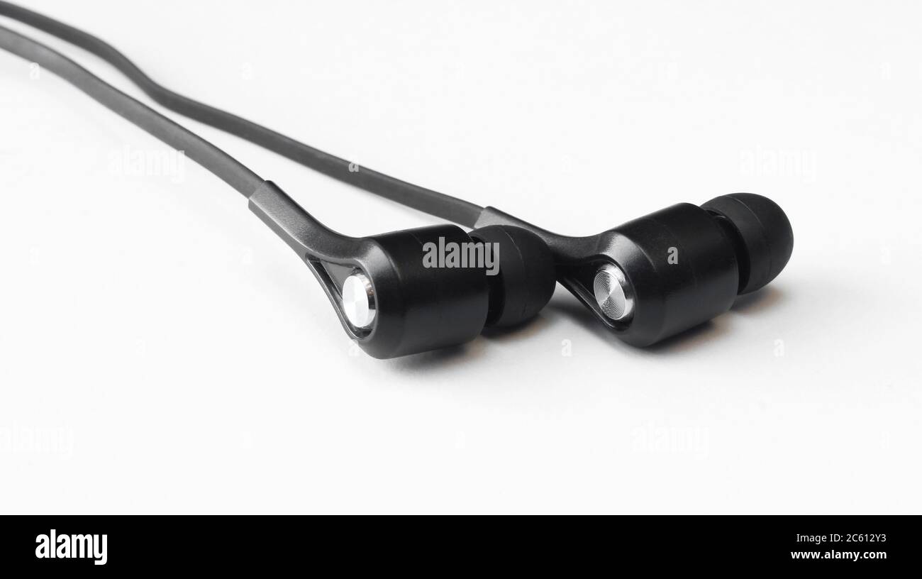 Black earphones close-up. Plastic headphones on white background Stock ...