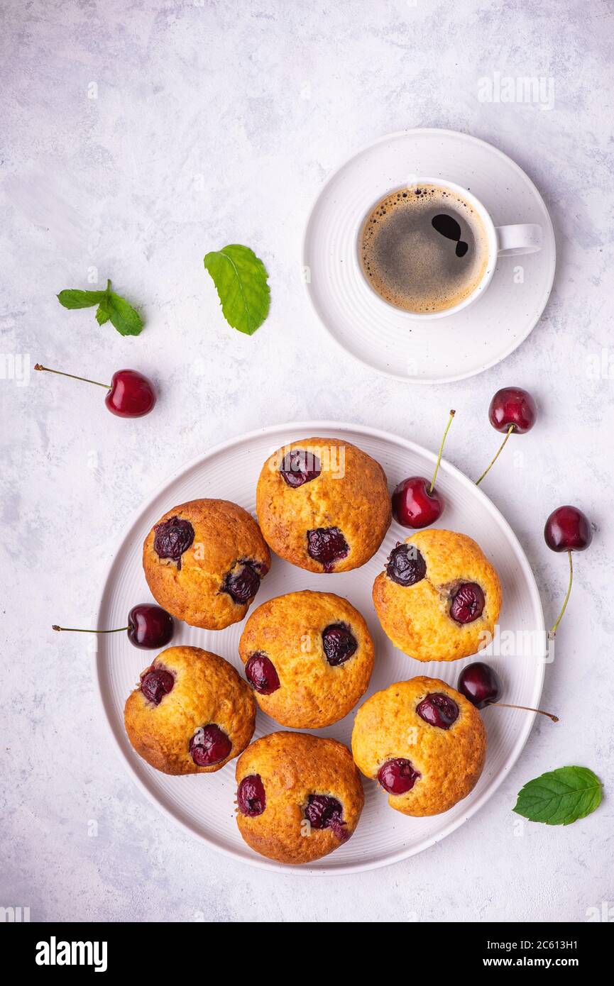 Homemade muffins with cherry on light background Stock Photo - Alamy