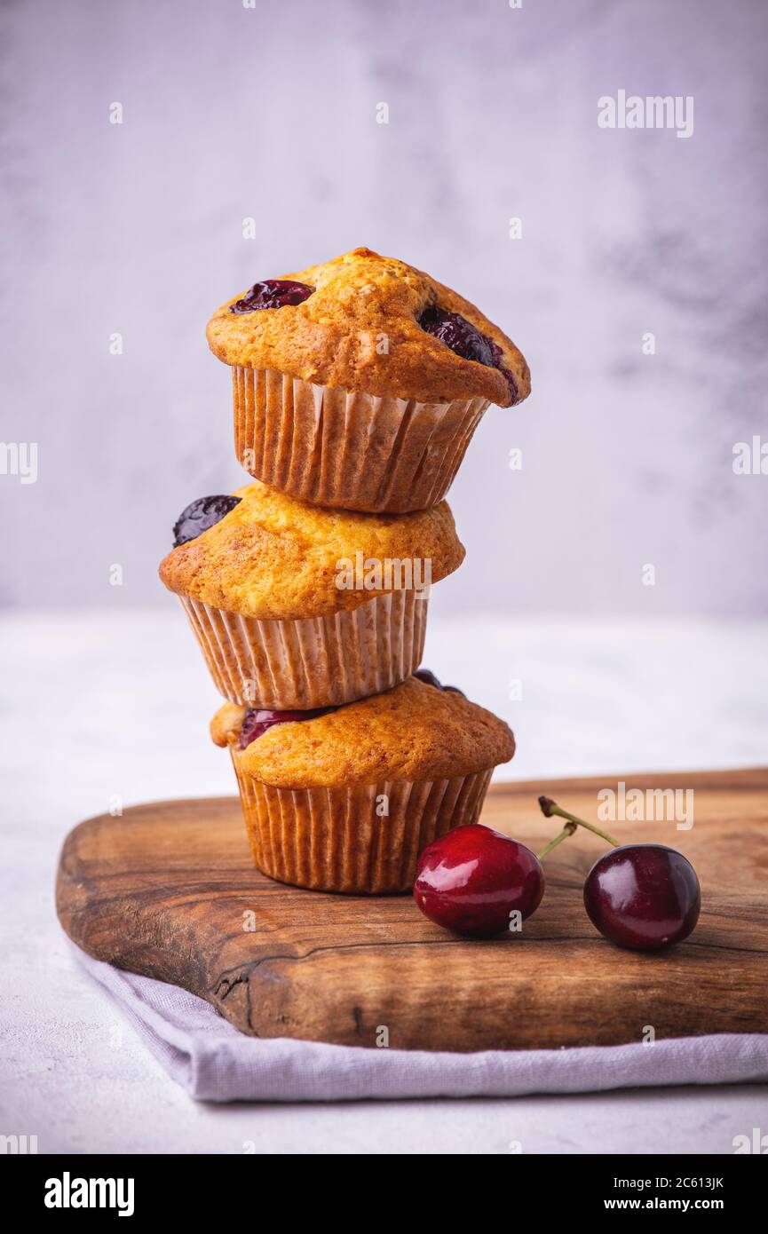 Homemade muffins with cherry on light background Stock Photo - Alamy