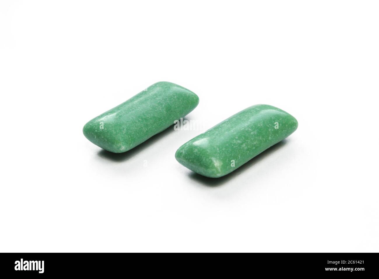 Two green mints isolated on white background. Sweet Chewing gums close ...