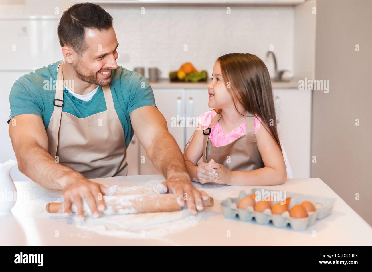 Joyful Father And Daughter Making Pastry Dough Together In Kitchen ...
