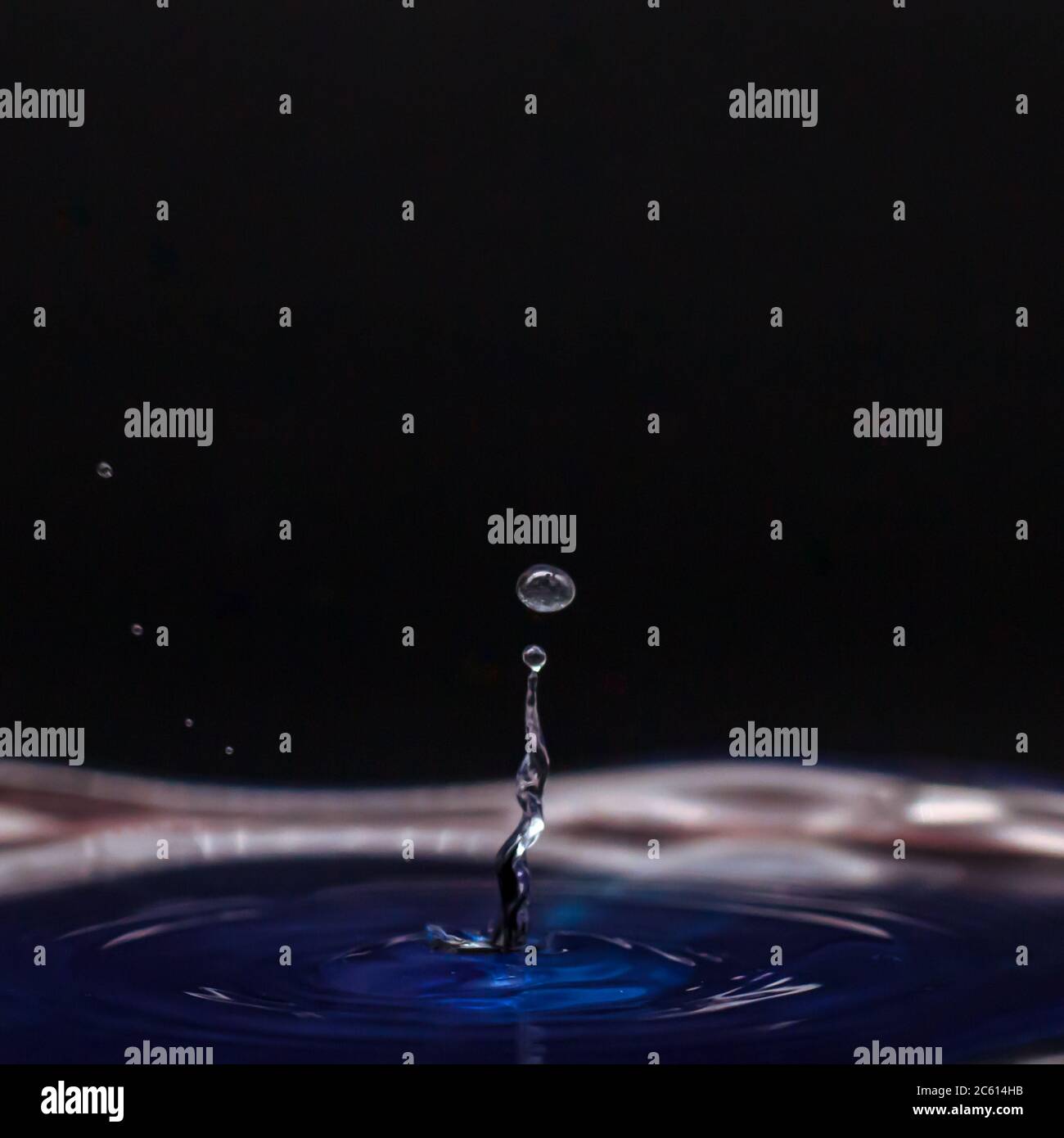 Blue color drop falling in water, creative forms Stock Photo - Alamy