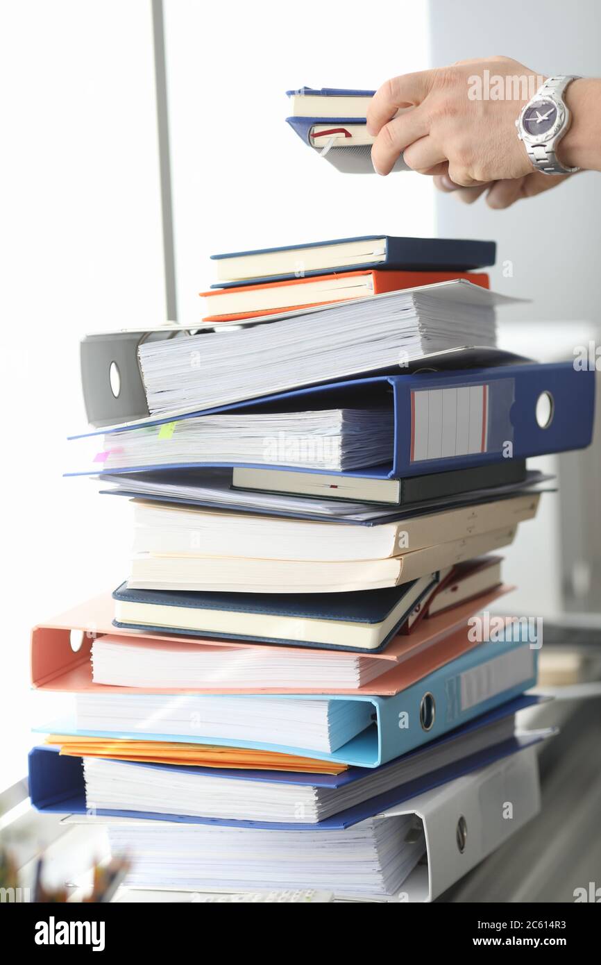 Male hands working in stacks of paper files Stock Photo - Alamy