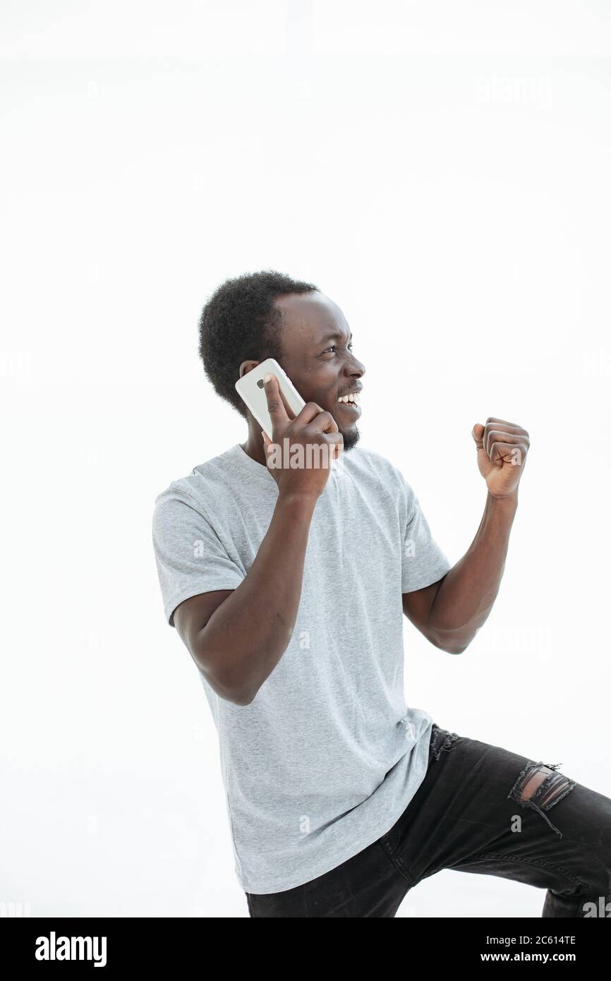happy guy talking on his cell phone. isolated on white Stock Photo - Alamy