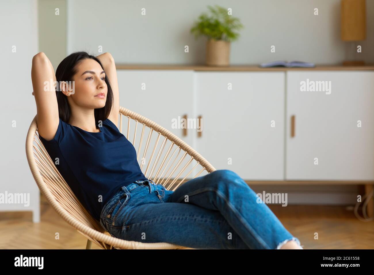 Woman sitting relaxed in armchair hi-res stock photography and images ...