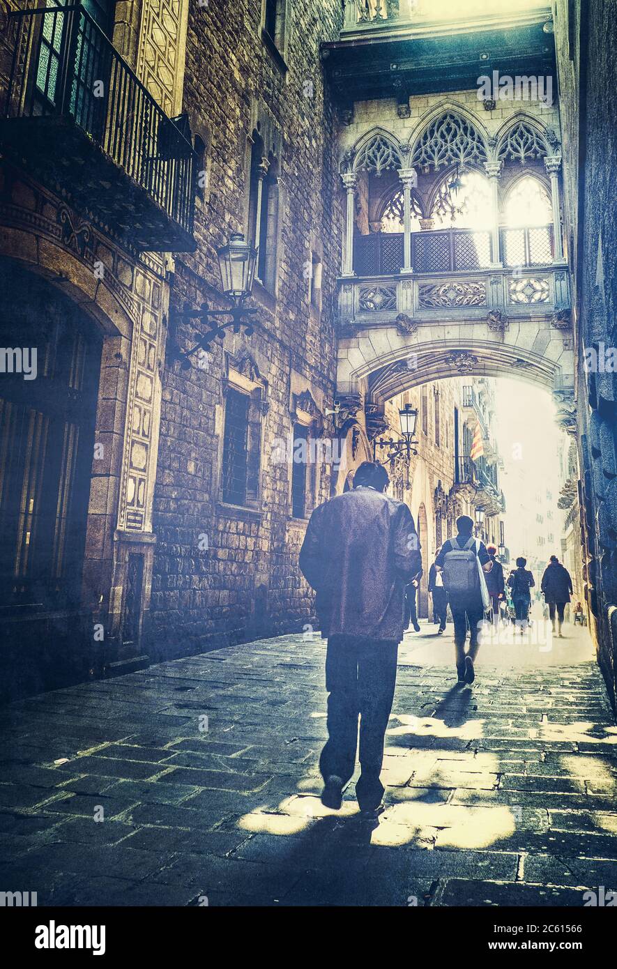 Hunched man walking through The Bridge of Sighs in the Gothic Quarter ...