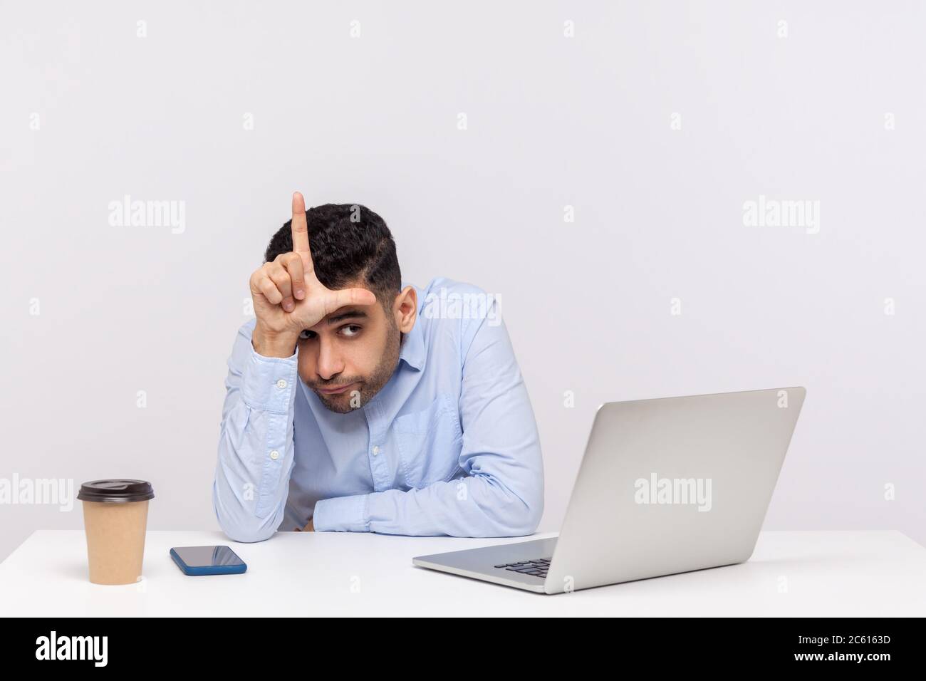 Dismissal, fired from job. Sad unluck young man employee sitting in ...
