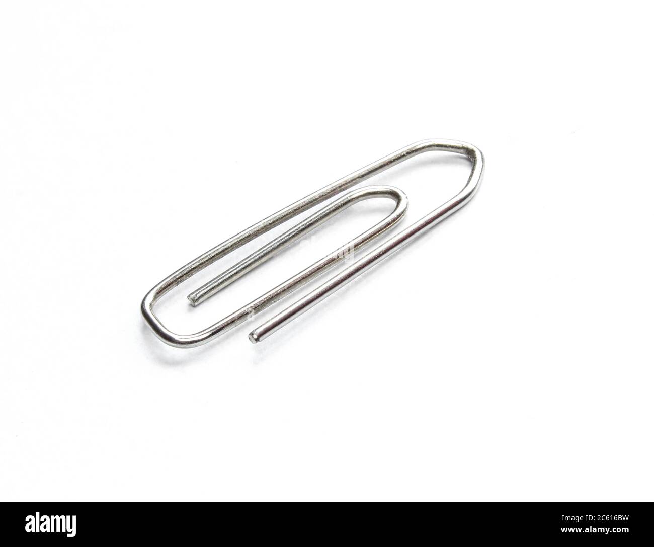 Silver metallic paperclip isolated on white background Stock Photo - Alamy