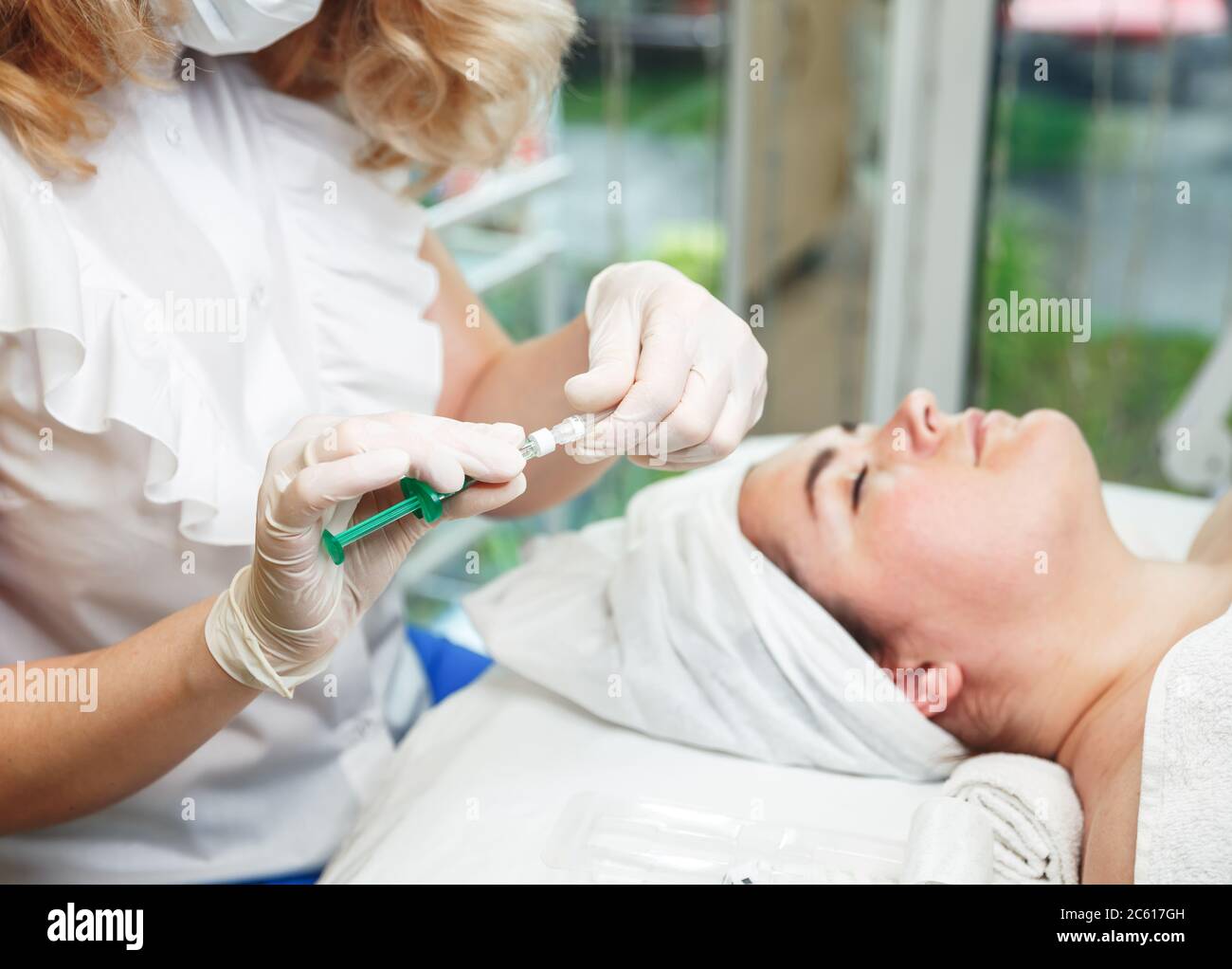 Woman getting injection in face hi-res stock photography and images - Alamy