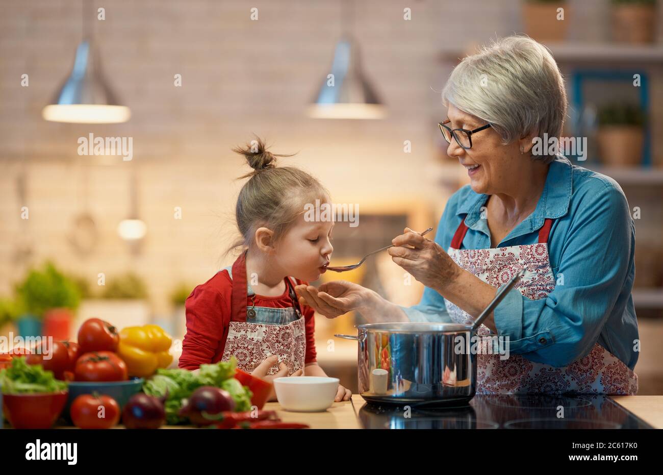 Healthy food at home. Happy family in the kitchen. Grandma and child ...