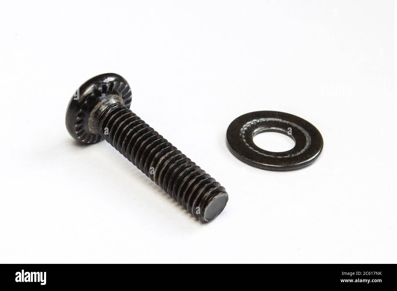 Black screw and washer isolated on white background. Small metallic ...