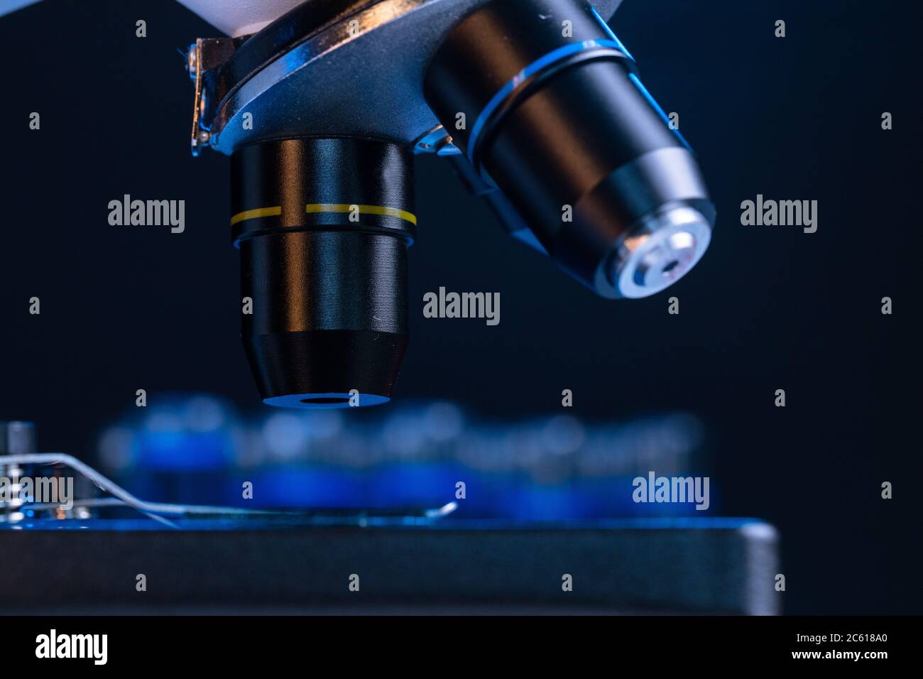 Microscope with lenses close up against dark background Stock Photo - Alamy