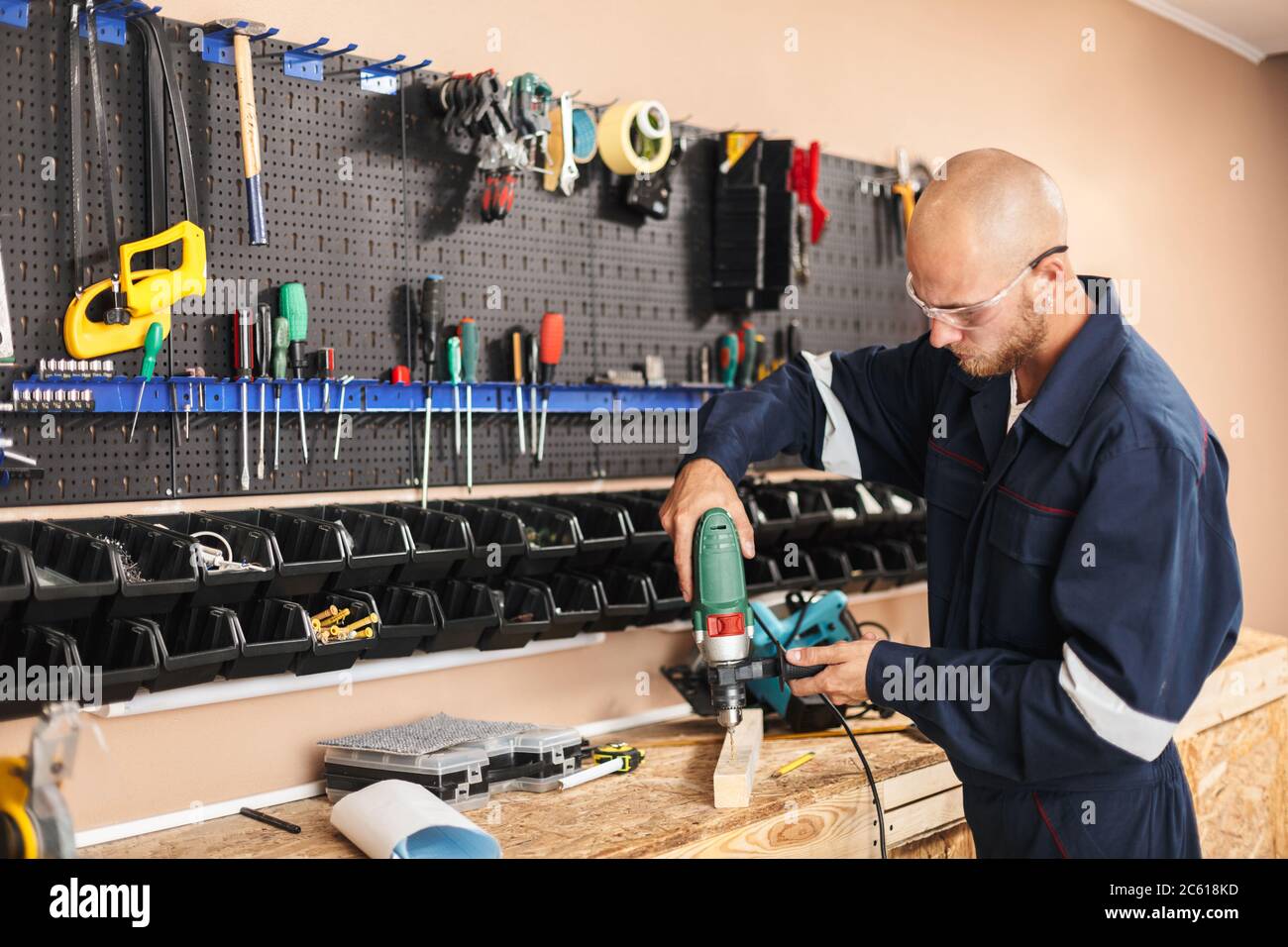 Young man using drill machine hi-res stock photography and images - Alamy