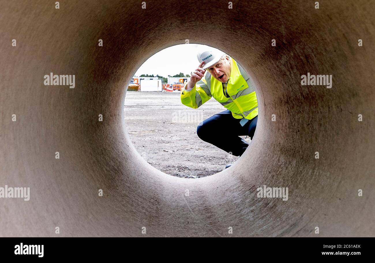 Prime Minister Boris Johnson looks through a large bore pipe during a ...