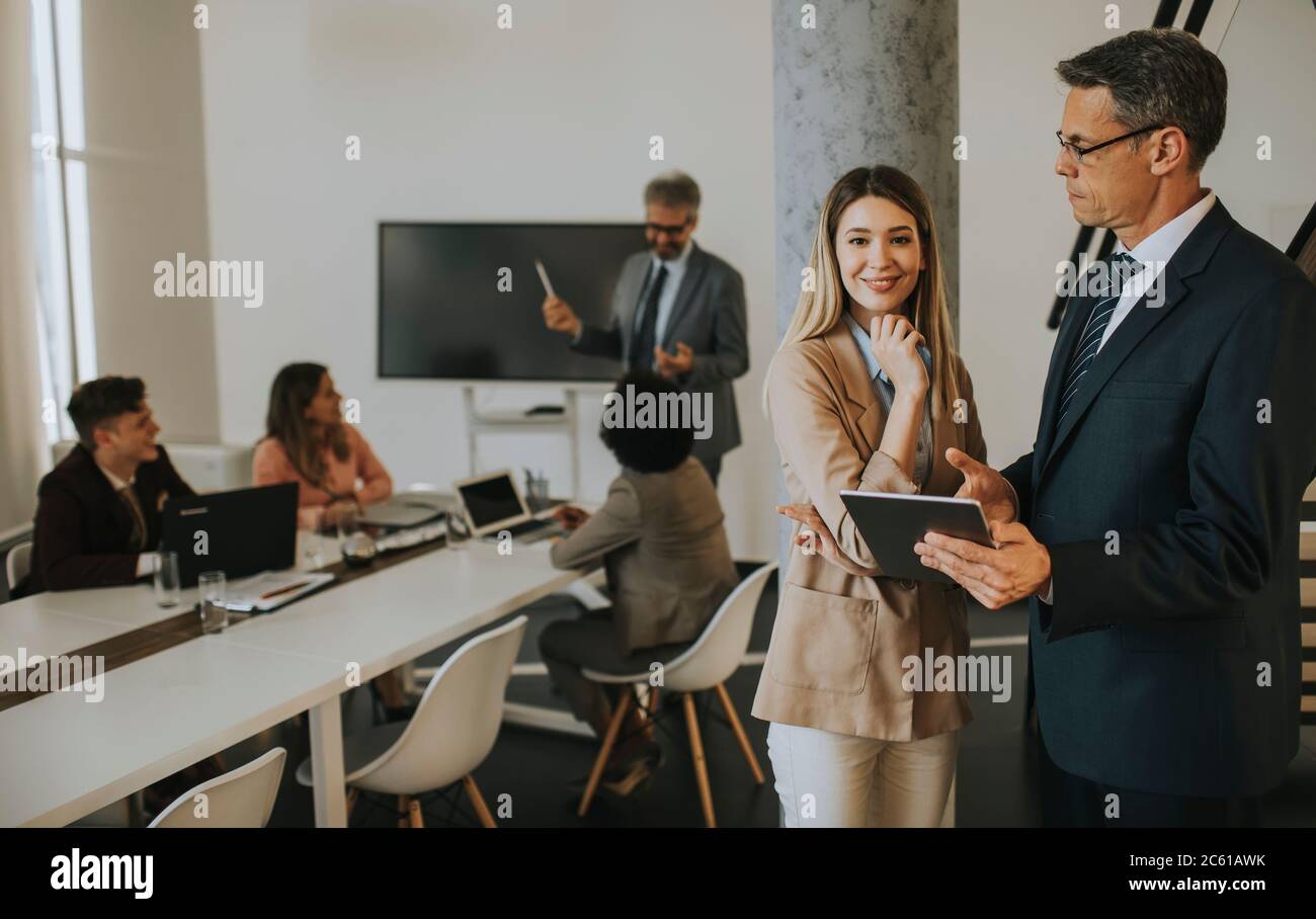 Male female business executives using hi-res stock photography and ...