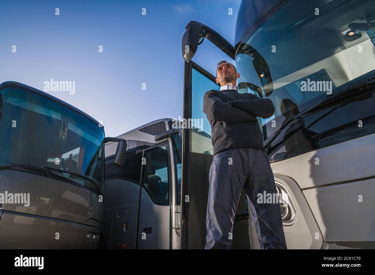 Shuttle Buses Transportation Business Owner in Front of His Fleet of ...