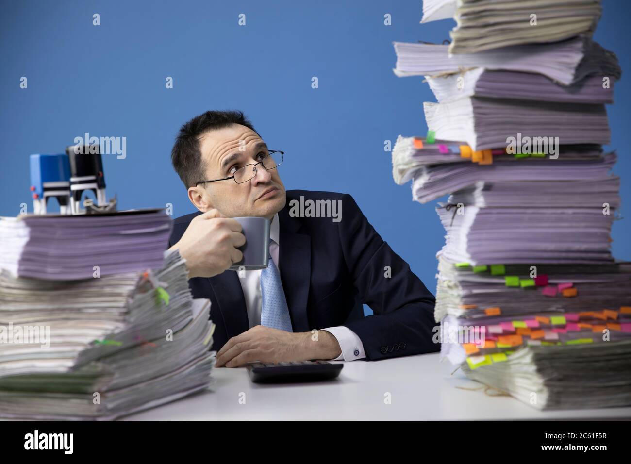 Overworked man pile of papers hi-res stock photography and images - Alamy