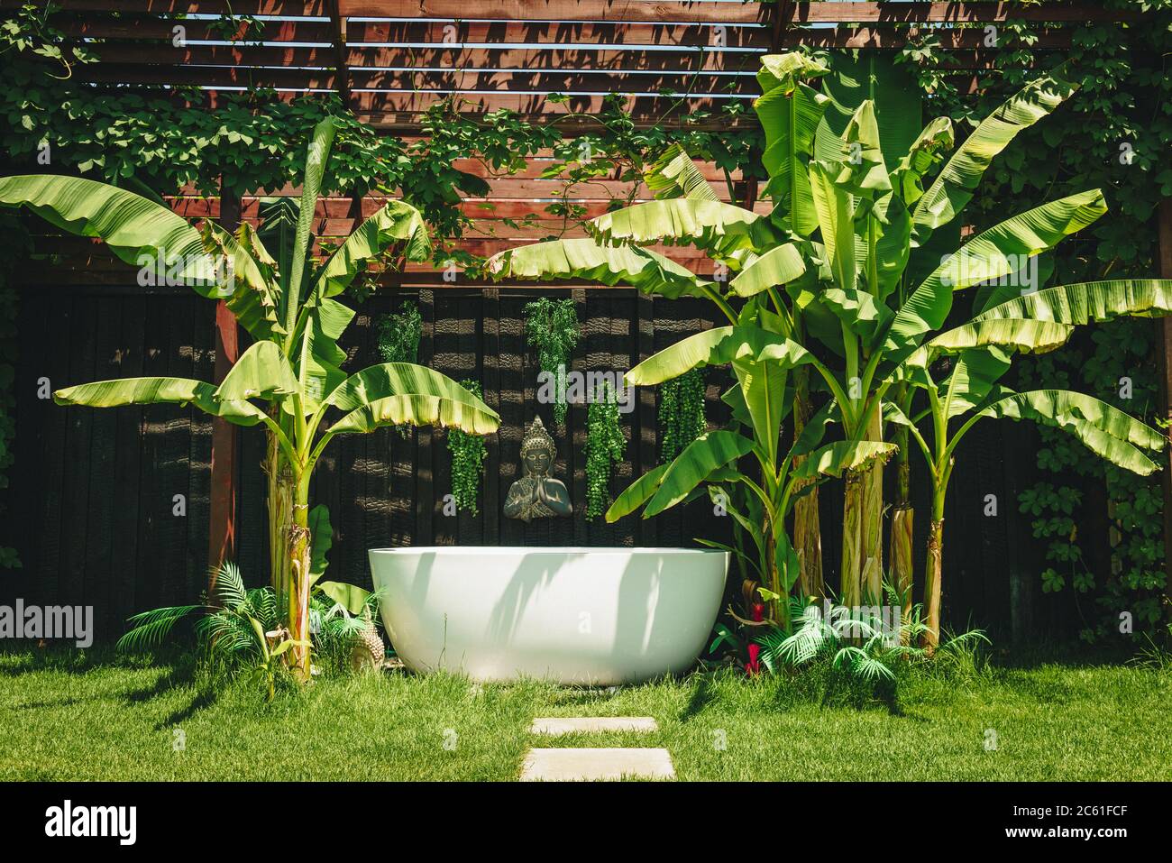 Outdoor white stone empty bath over green tropical nature background ...