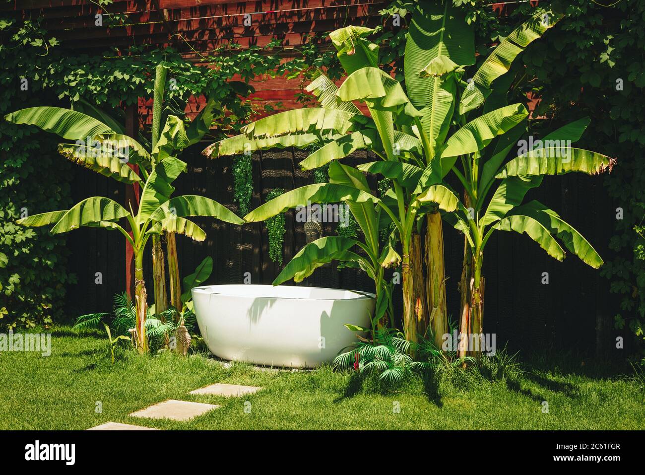 Outdoor white stone empty bath over green tropical nature background ...