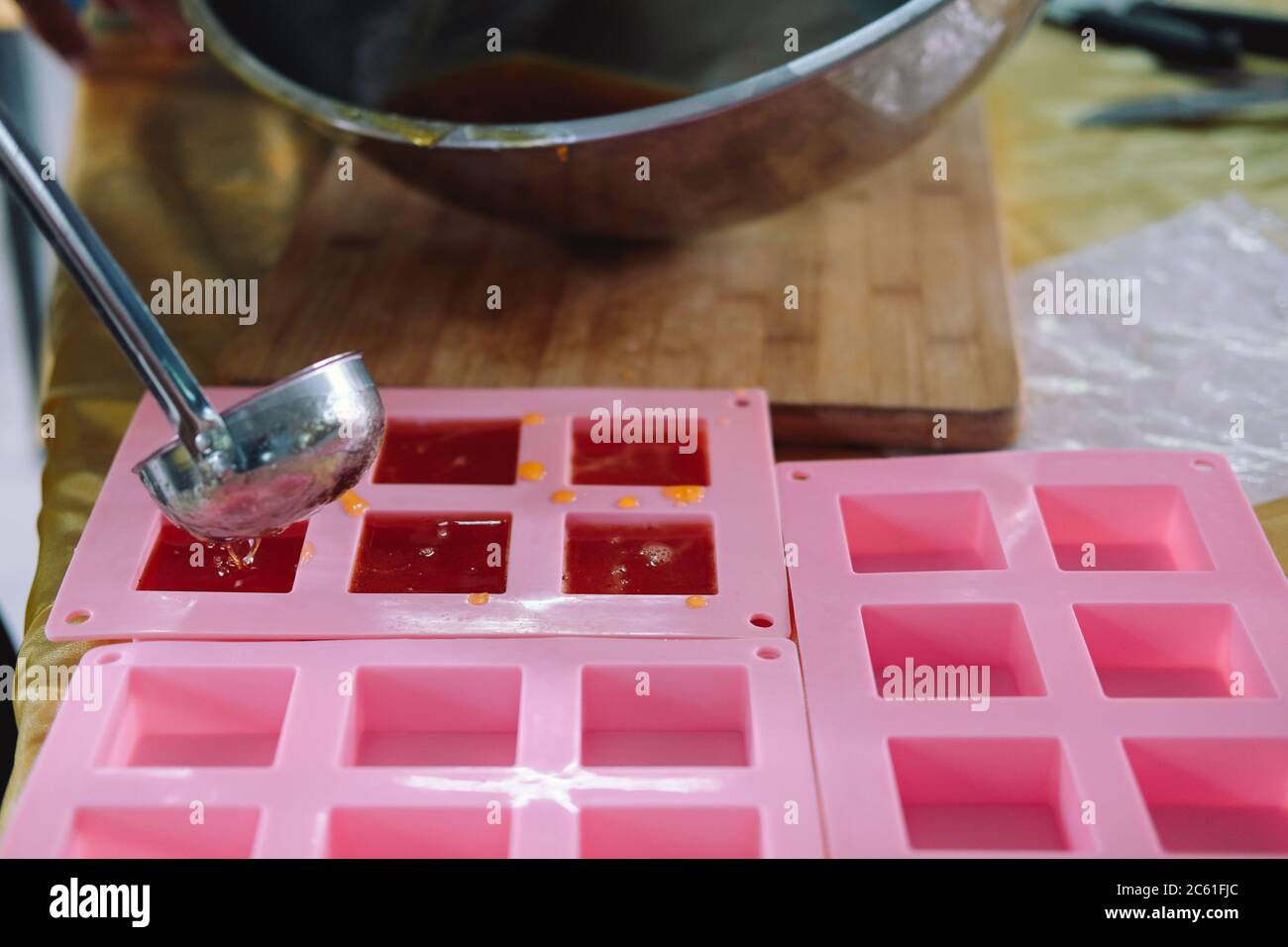 hand pouring homemade soap mixture on plastic form Stock Photo - Alamy