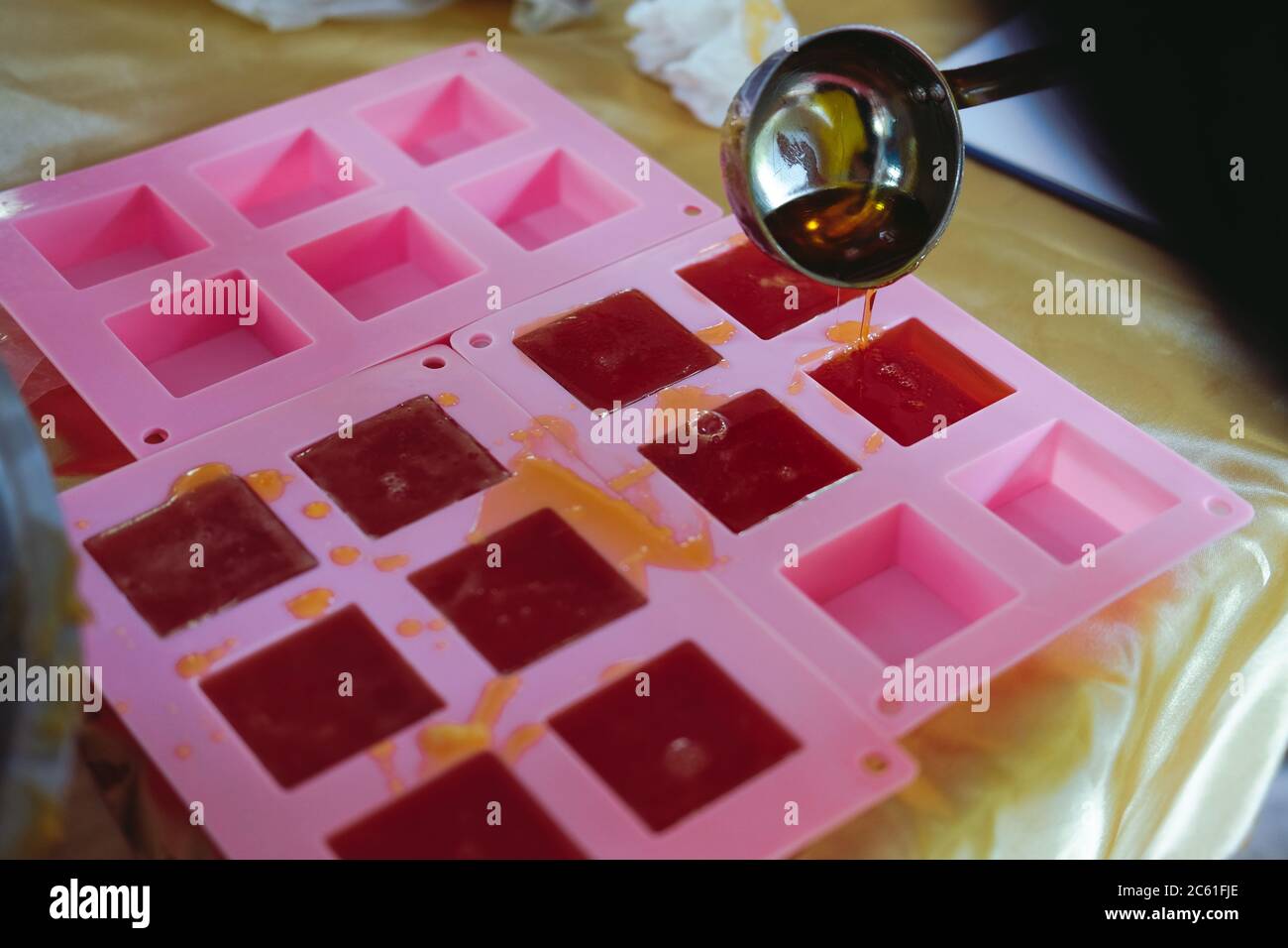 hand pouring homemade soap mixture on plastic form Stock Photo - Alamy