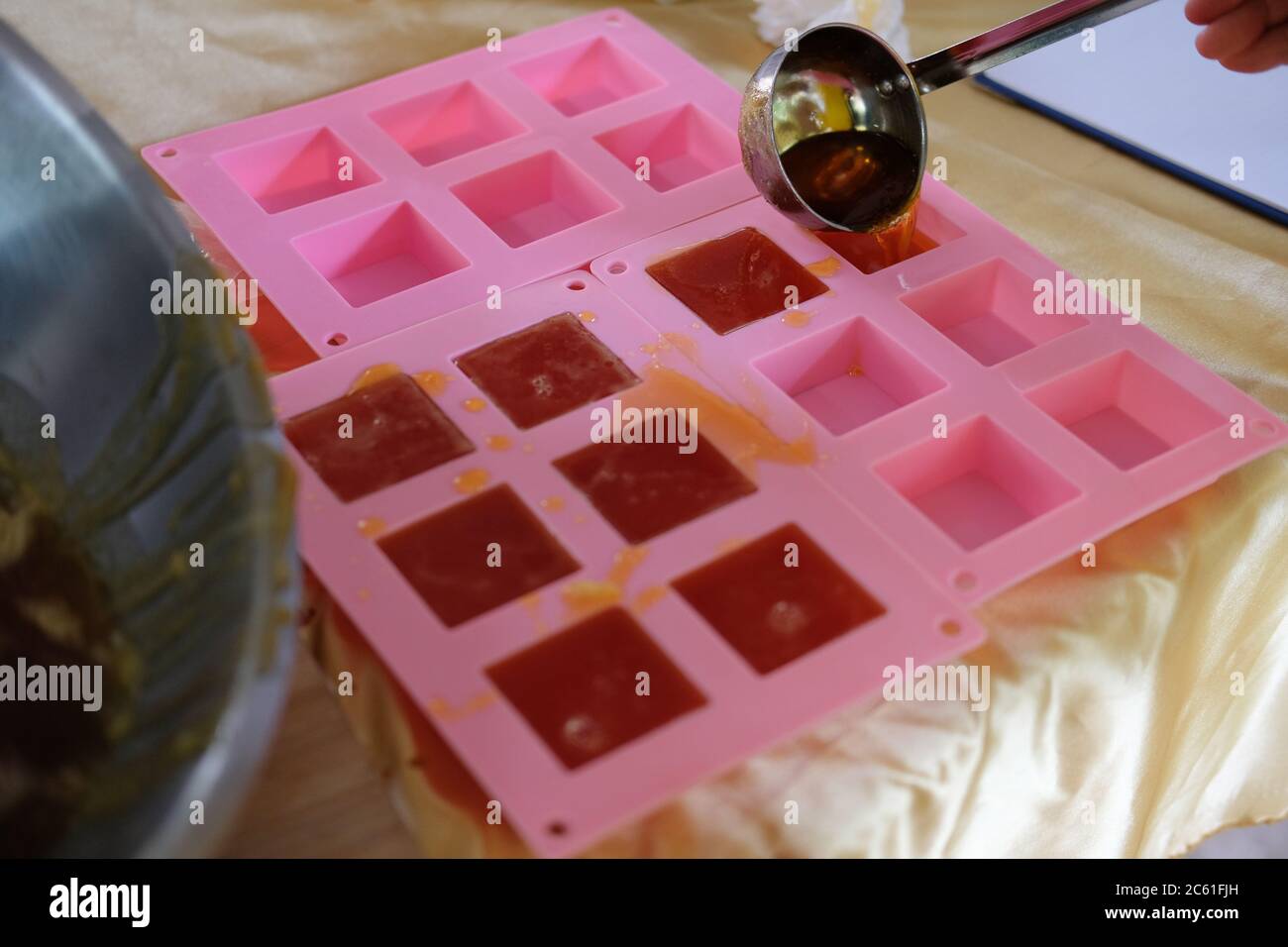hand pouring homemade soap mixture on plastic form Stock Photo - Alamy