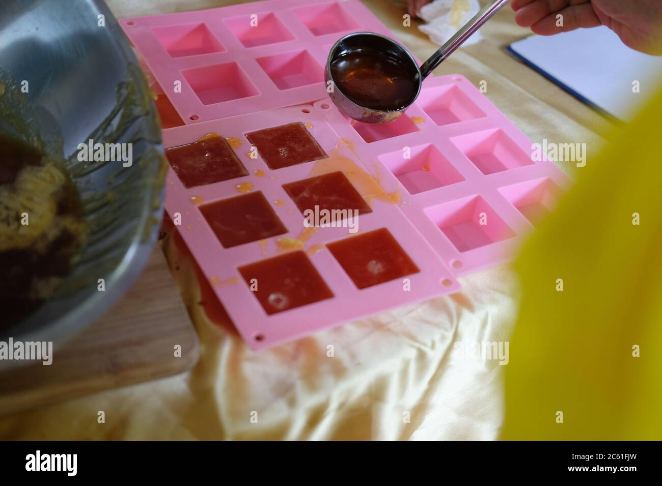hand pouring homemade soap mixture on plastic form Stock Photo - Alamy