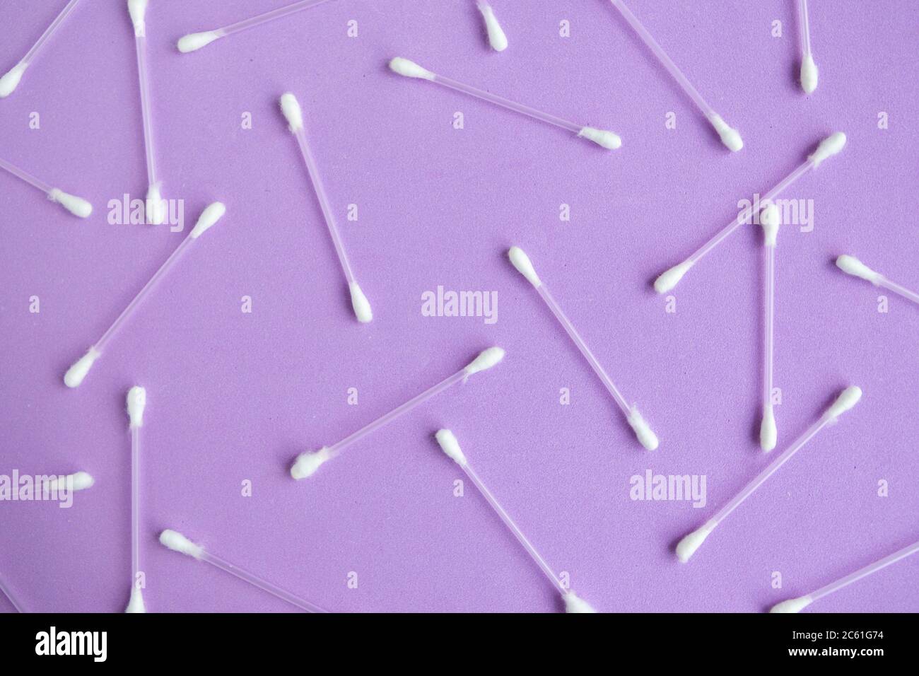 Cotton buds pattern on purple background, top view Stock Photo - Alamy