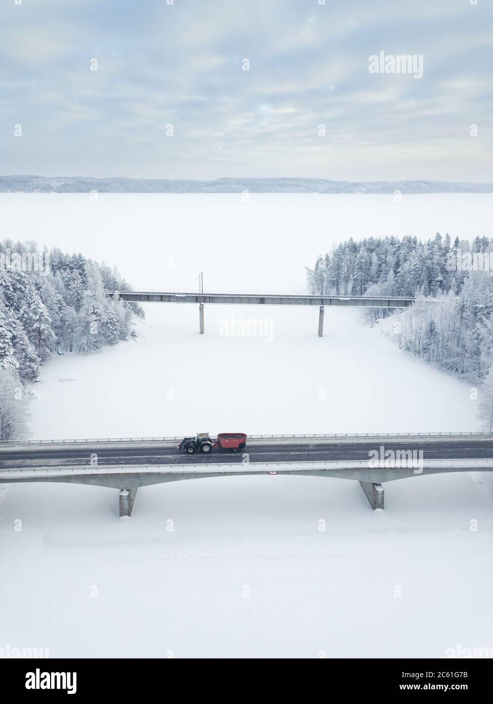 Aerial view of bridges with vehicle, bridges over ice-covered lake ...