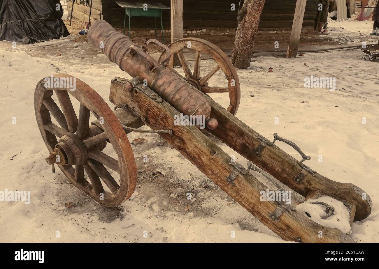 Antique brass cannon with wooden carriage and wheels Stock Photo - Alamy