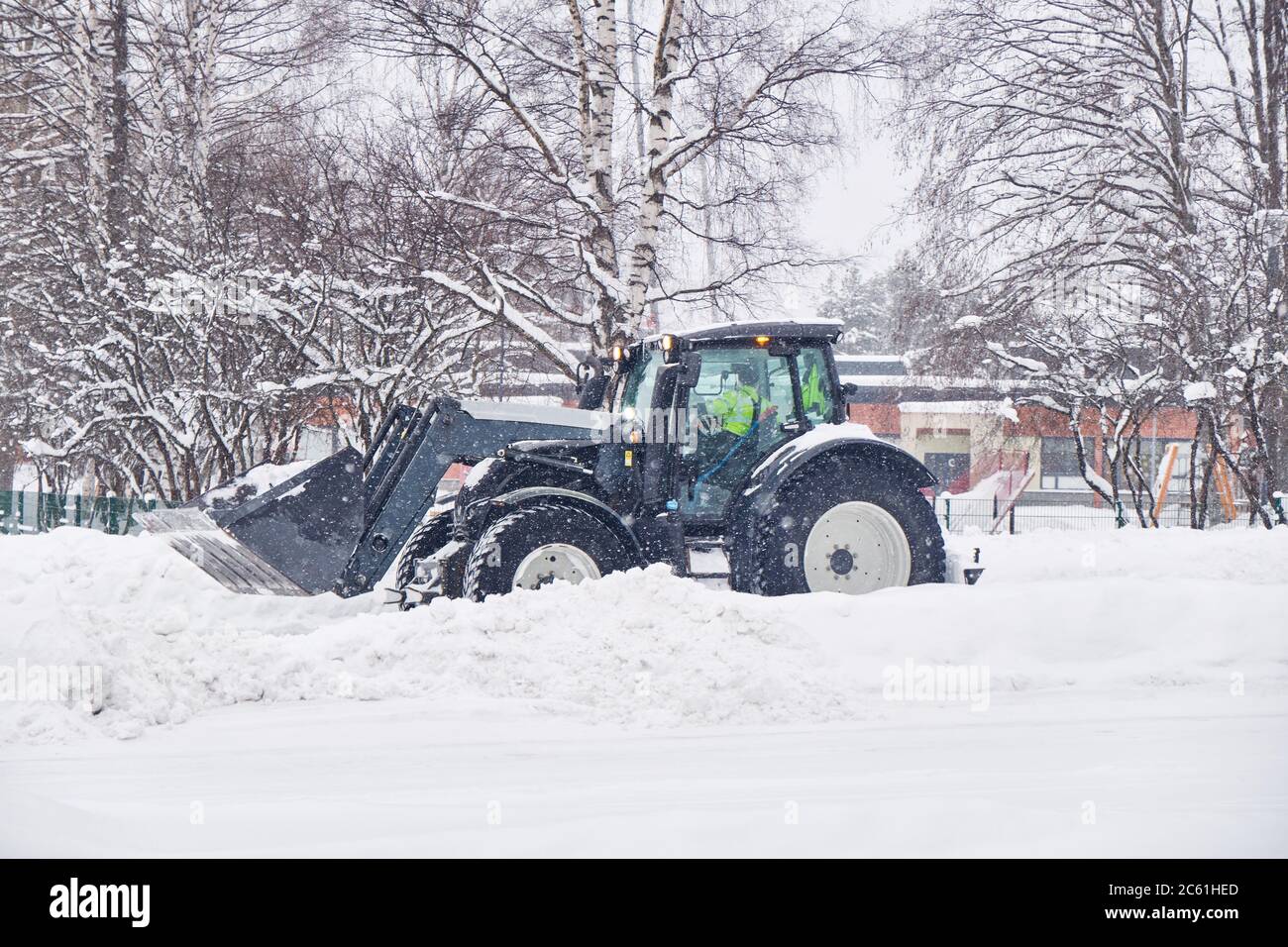 Tractor clearing street after a snow storm Stock Photo - Alamy