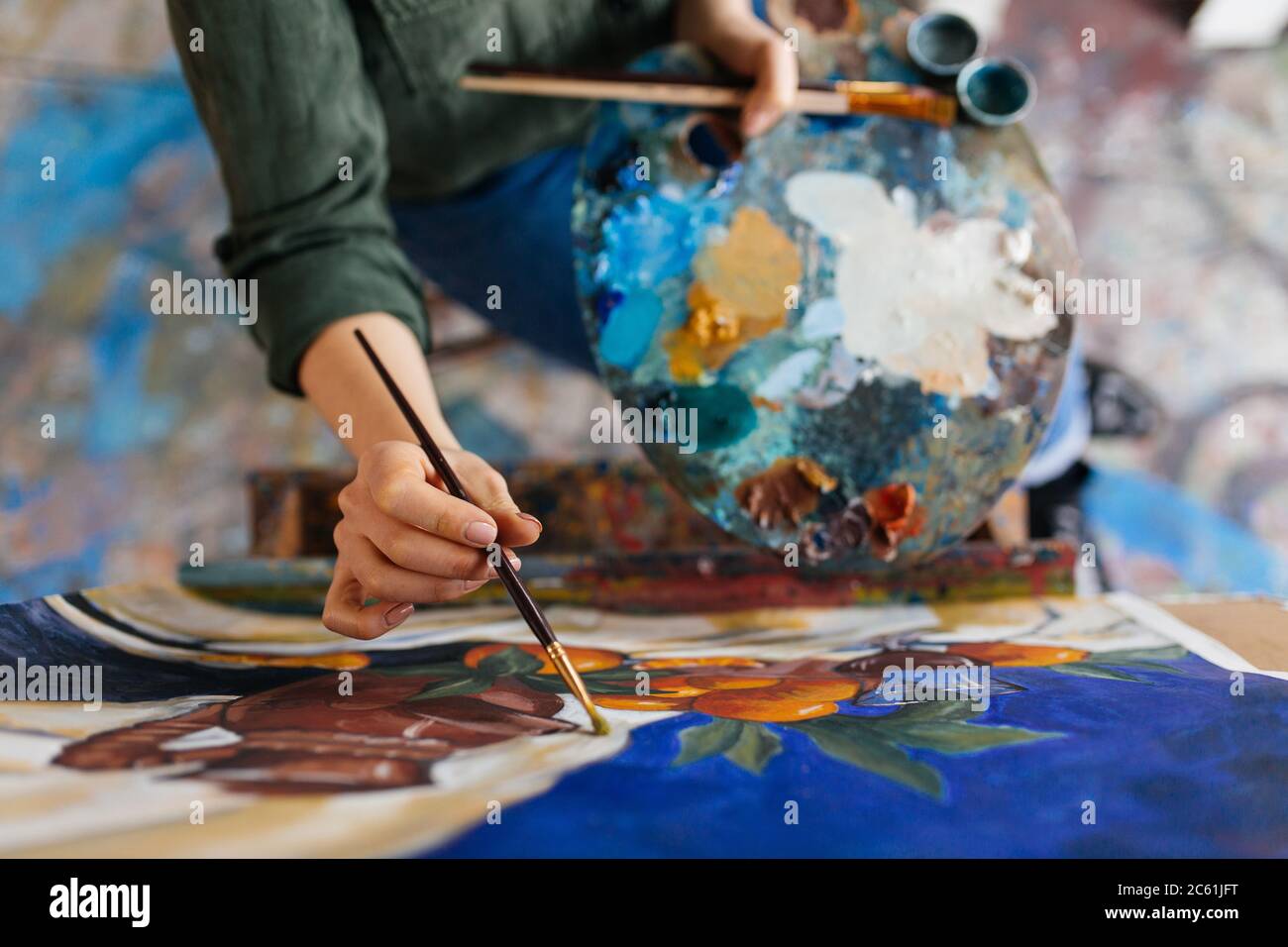 Top view of attractive woman hands drawing amazing picture on canvas in ...